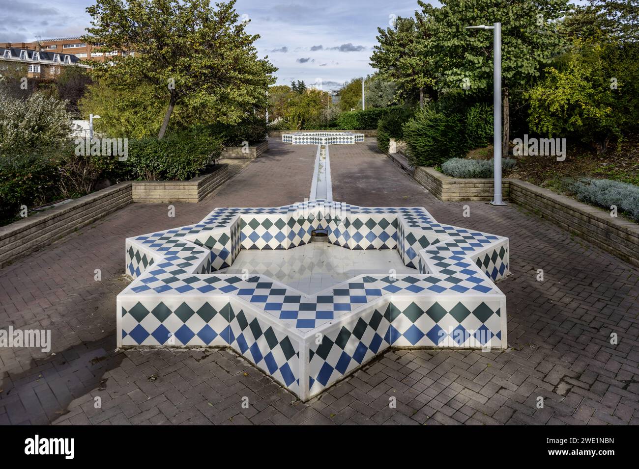 Arabic style fountains within an urban park with lots of leafy trees ...