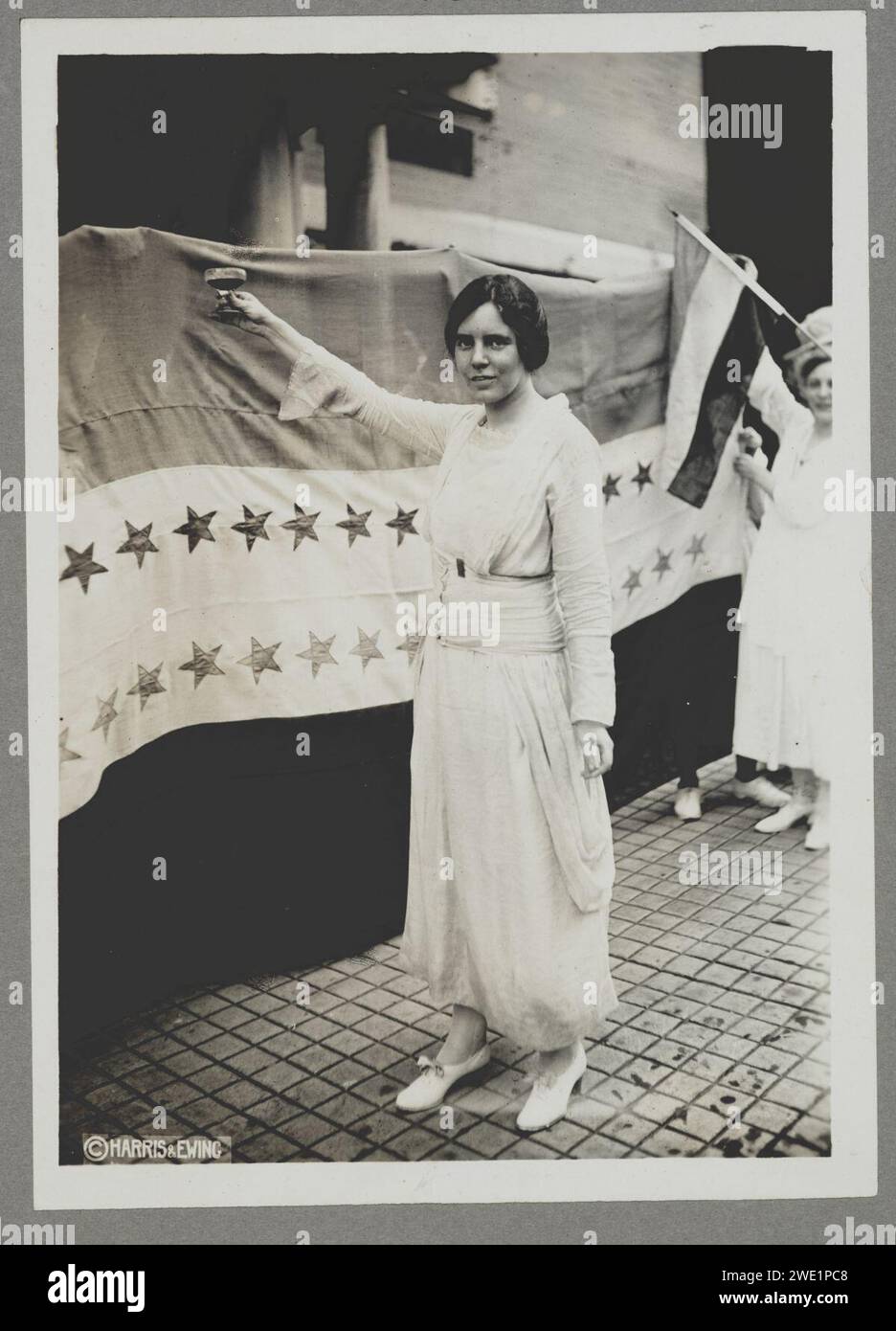 Alice Paul, full-length portrait, standing, facing left, raising glass ...