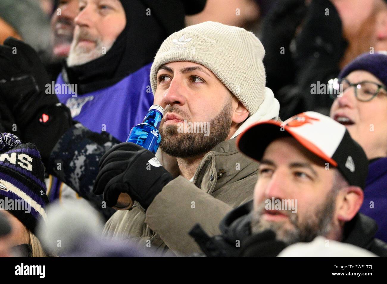 A spectator looks on with a Bud Light during the second half of an NFL ...