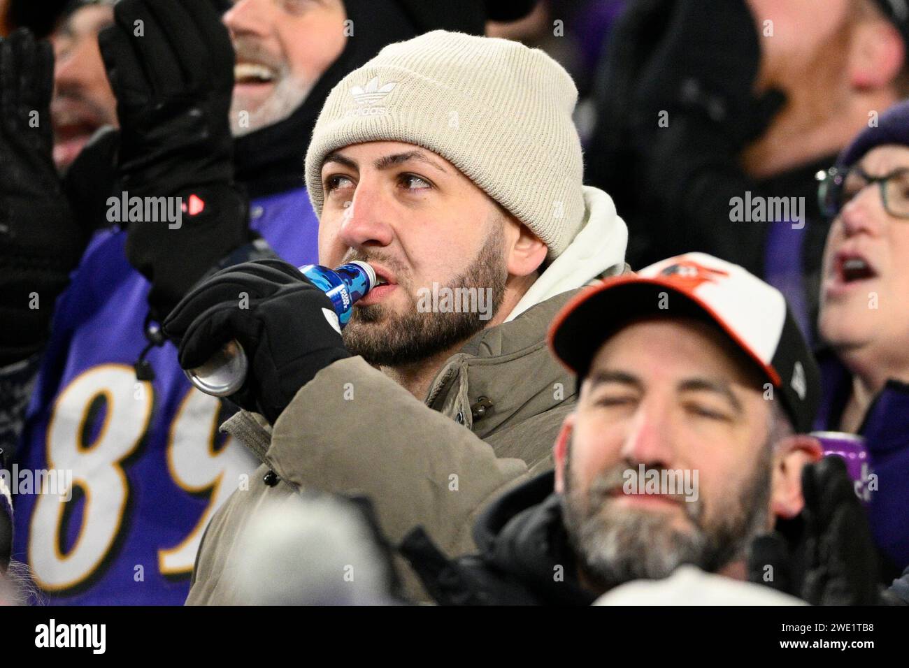 A spectator looks on with a Bud Light during the second half of an NFL ...