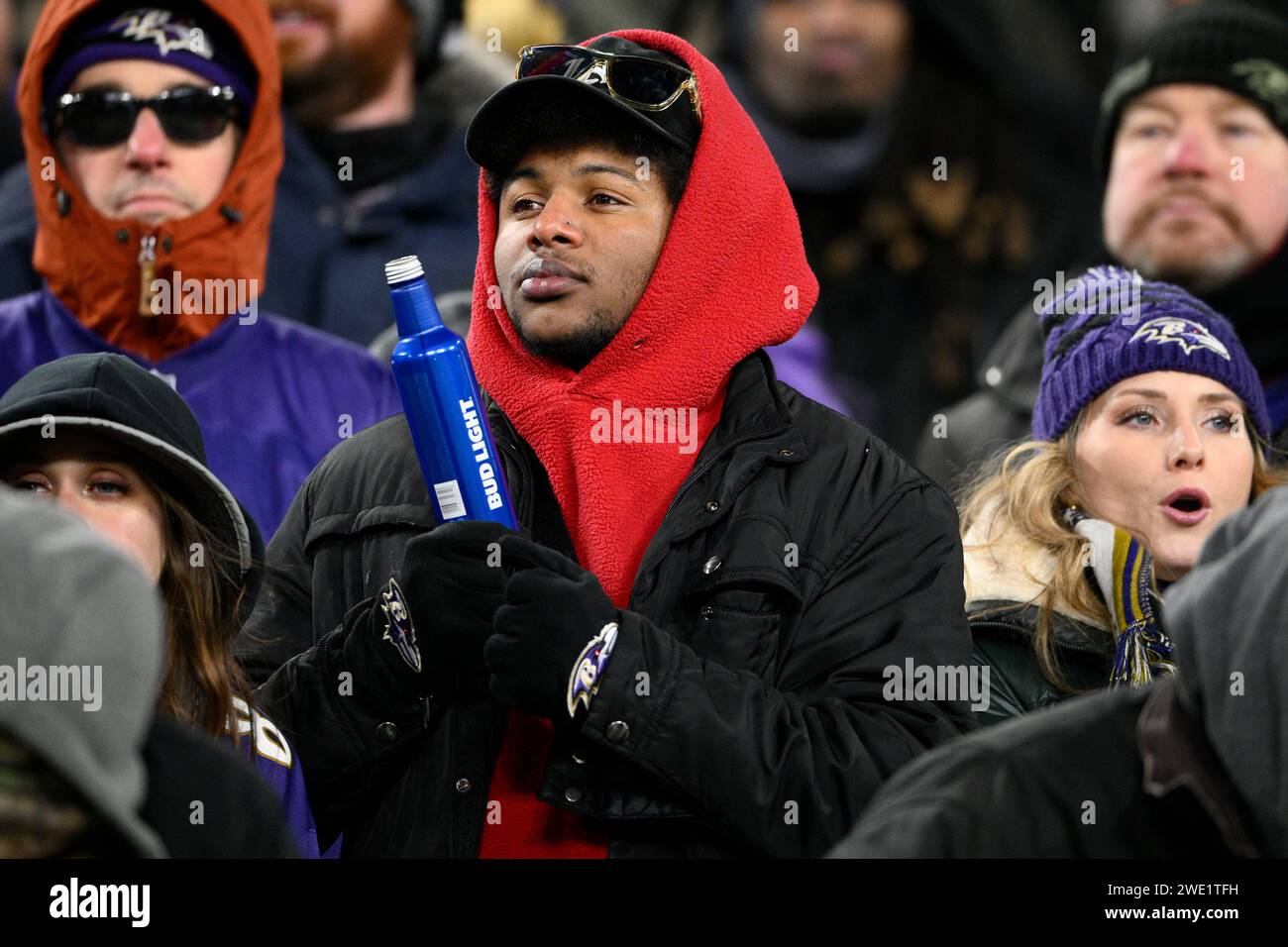 A spectator looks on with a Bud Light during the second half of an NFL ...