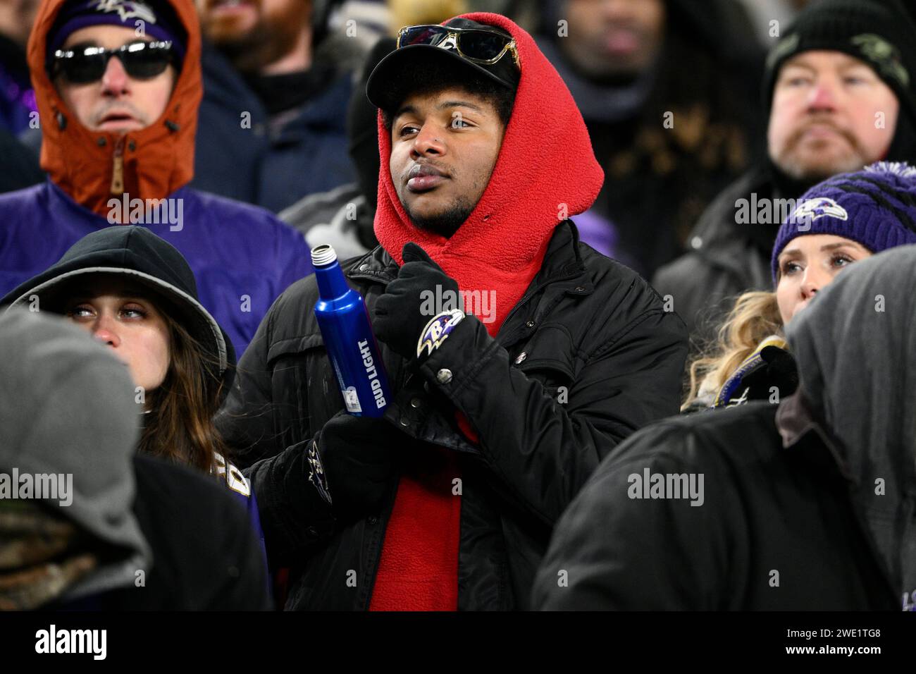 A spectator looks on with a Bud Light during the second half of an NFL ...