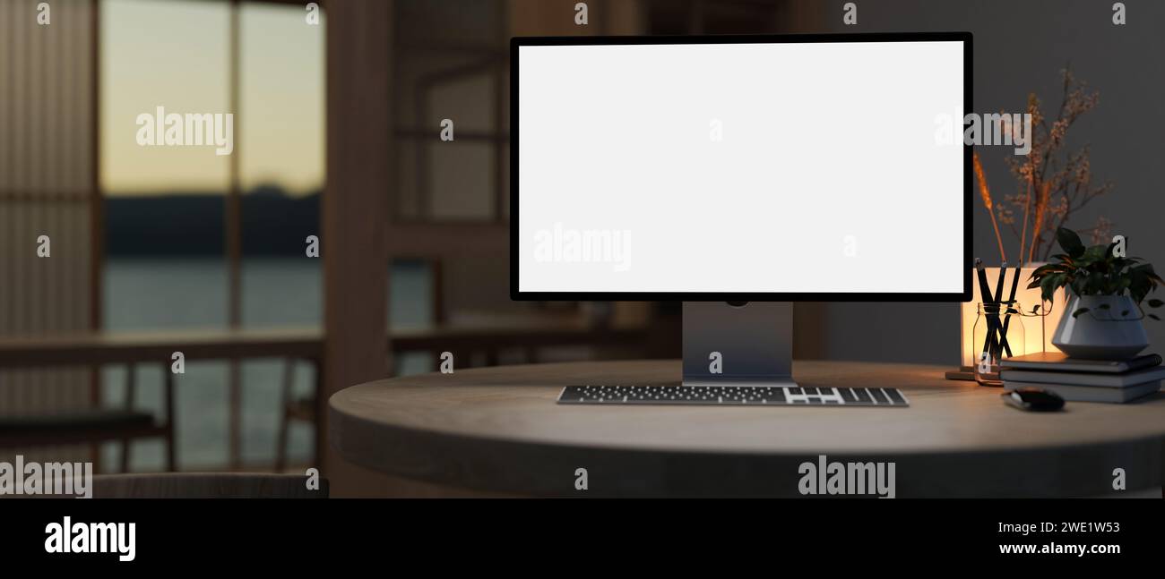 A white-screen PC computer and accessories on a table in a modern dark ...