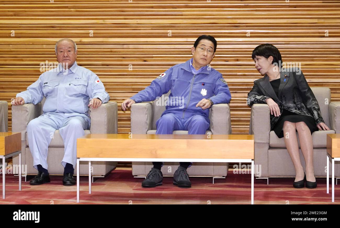 Japanese Prime Minister Fumio Kishida (C) chats with Sanae Takaichi ...