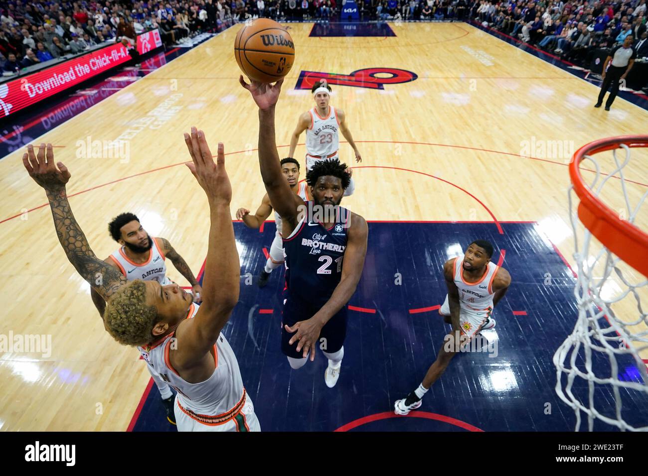 Philadelphia 76ers' Joel Embiid, center, goes up for a shot between San ...