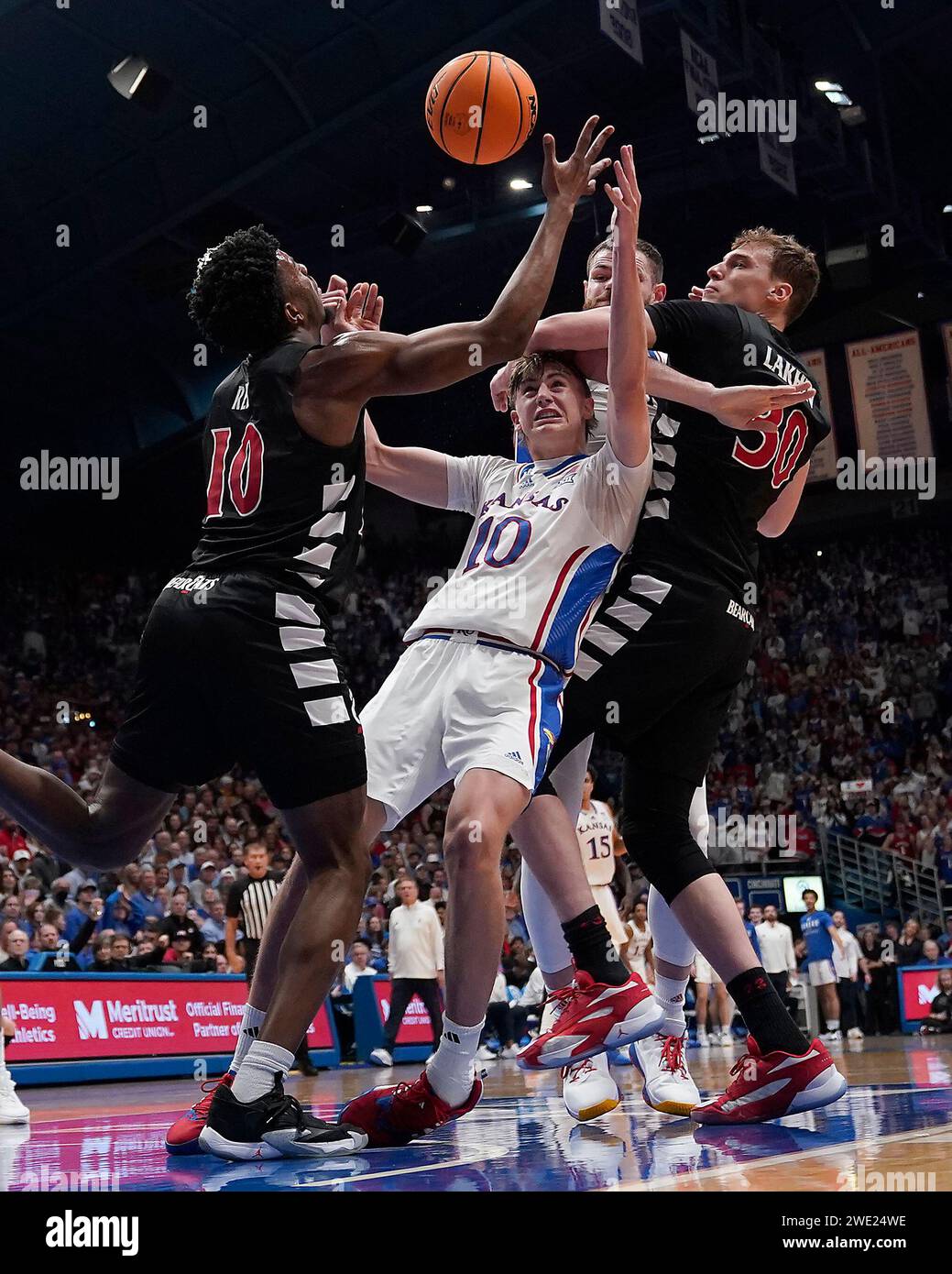 Cincinnati guard Josh Reed (10) and forward Viktor Lakhin (30) battle ...