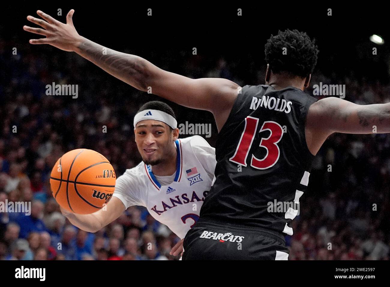 Kansas guard Dajuan Harris Jr. (3) passes around Cincinnati forward ...