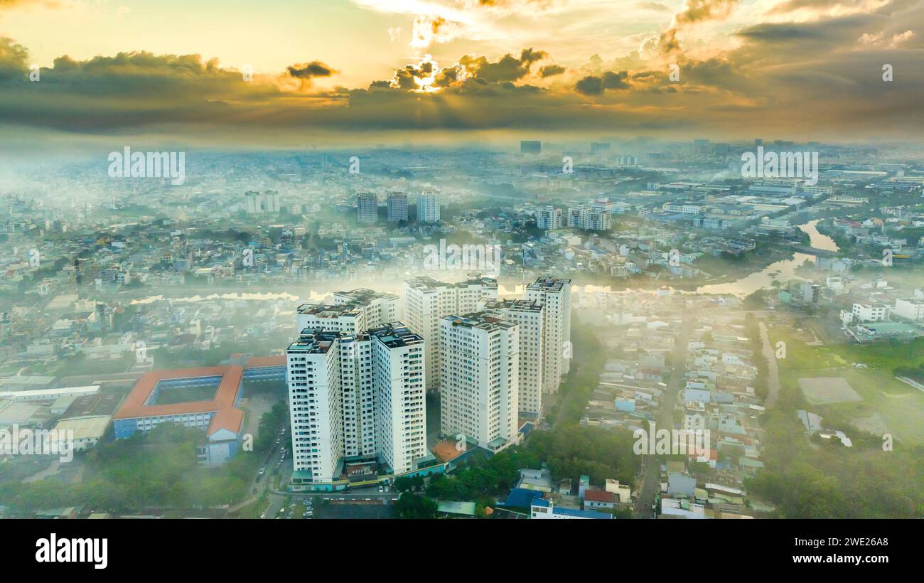 Aerial view of Saigon cityscape at morning with misty sky in Southern Vietnam. Urban development ...