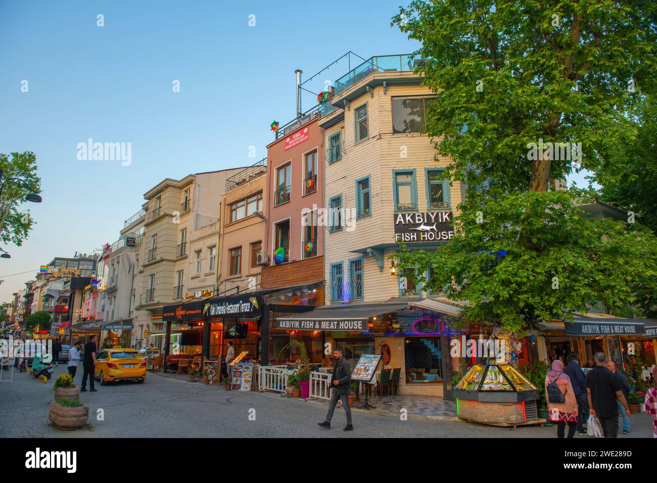 Historic commercial buildings on Akbiyik Caddesi Street at sunset in ...