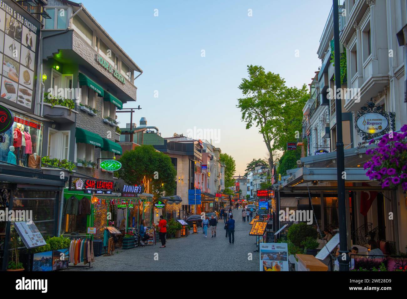 Historic commercial buildings on Akbiyik Caddesi Street at sunset in ...