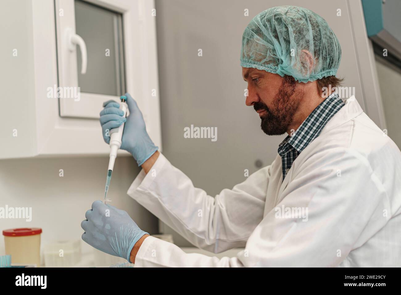 Scientist dropping substance in test tube in research laboratory ...