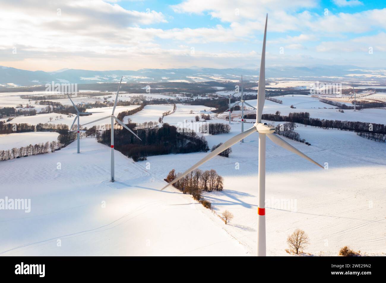 A wind turbine park in the winter field as a hub of renewable energy ...