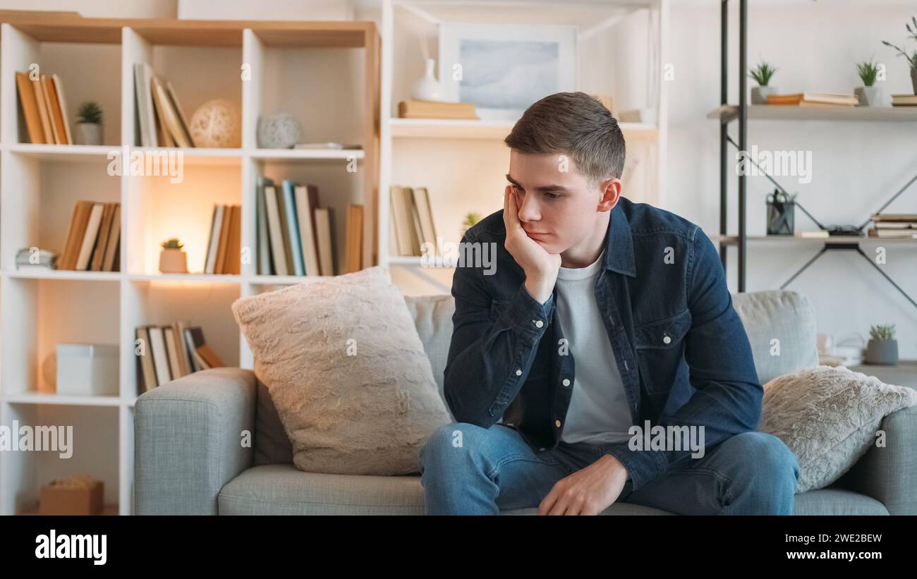 Frustration depression bad mood man couch home Stock Photo - Alamy