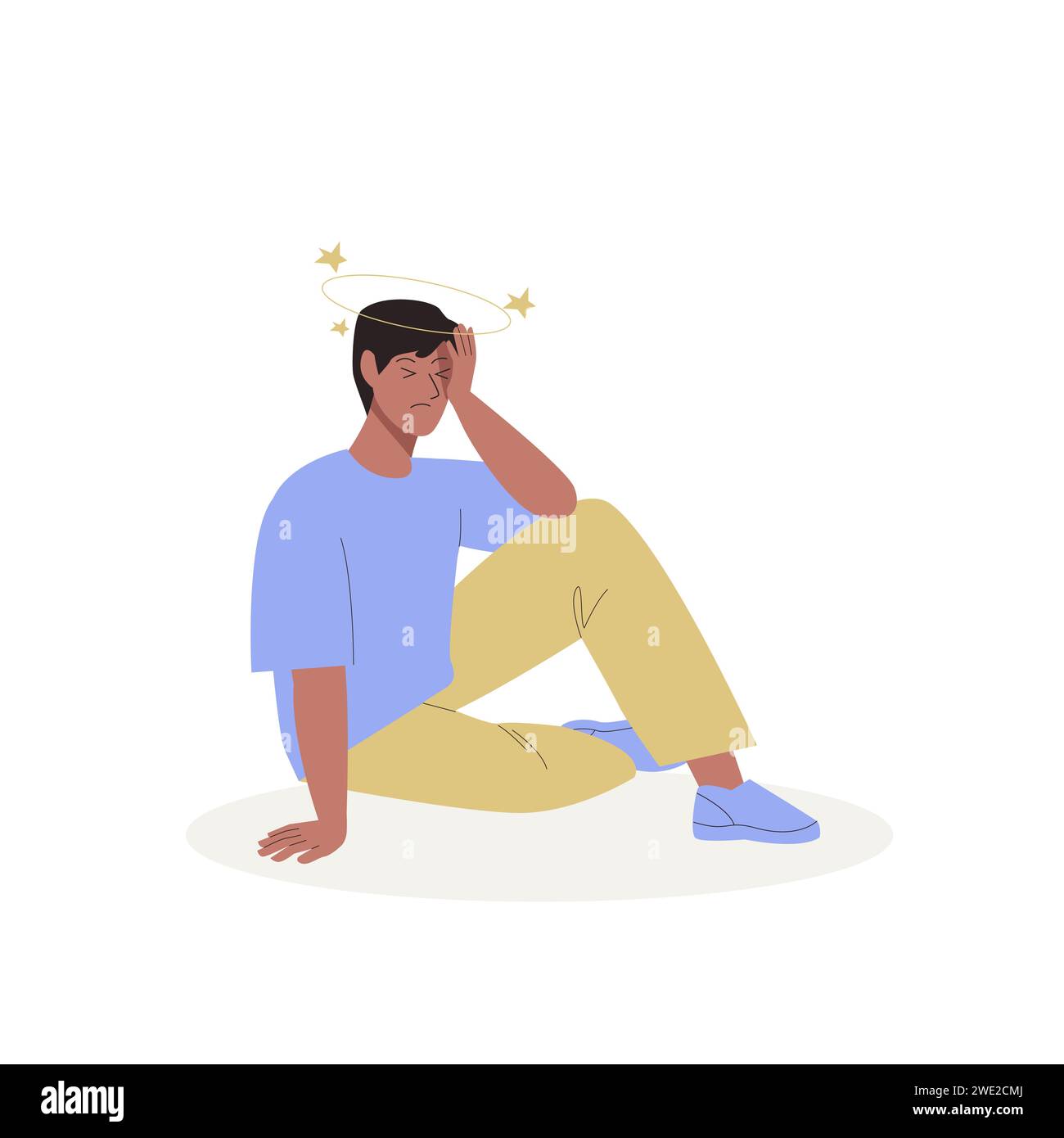 Young man sits on the ground with a head injury after accidental fall ...