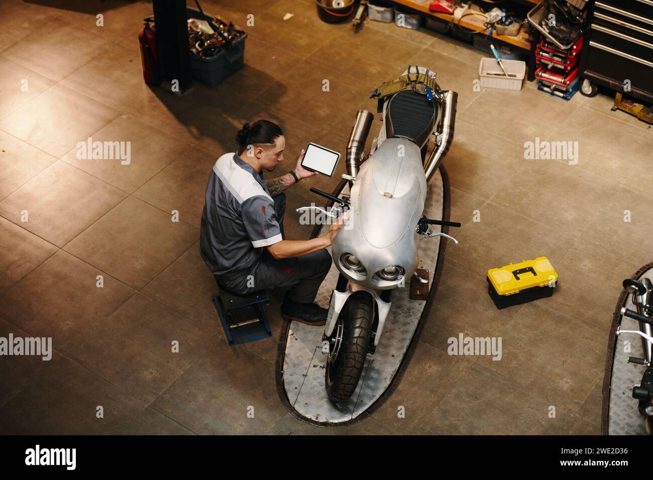 Mechanic using application on tablet computer when detecting problems ...