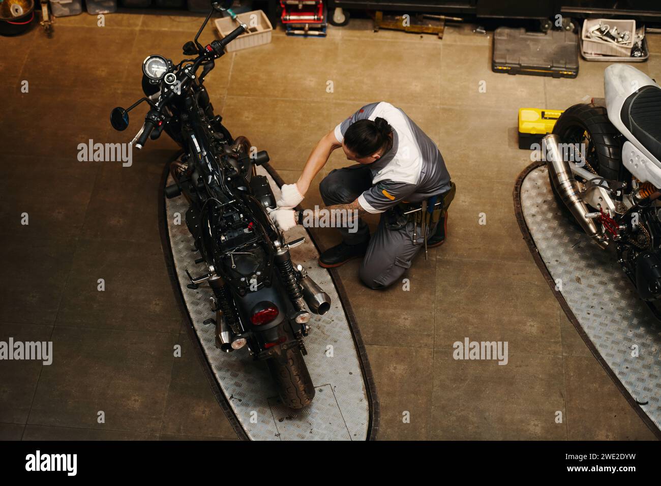Mechanic disassembling motorcycle to change broken part Stock Photo - Alamy