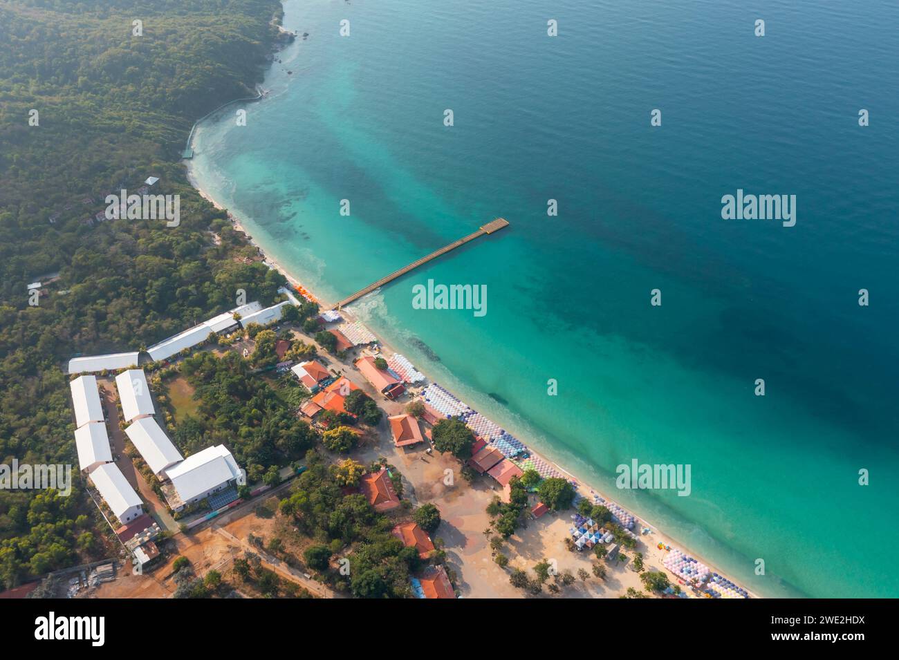 Aerial top view of colorful umbrellas on sandy beach, swim in blue sea ...