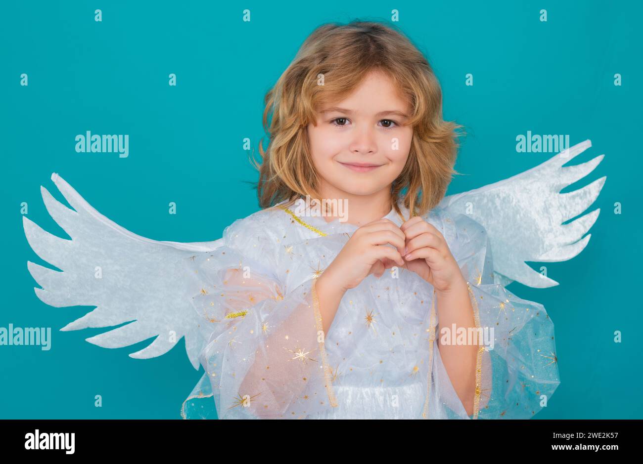 Kid wearing angel costume white dress and feather wings. Innocent child ...