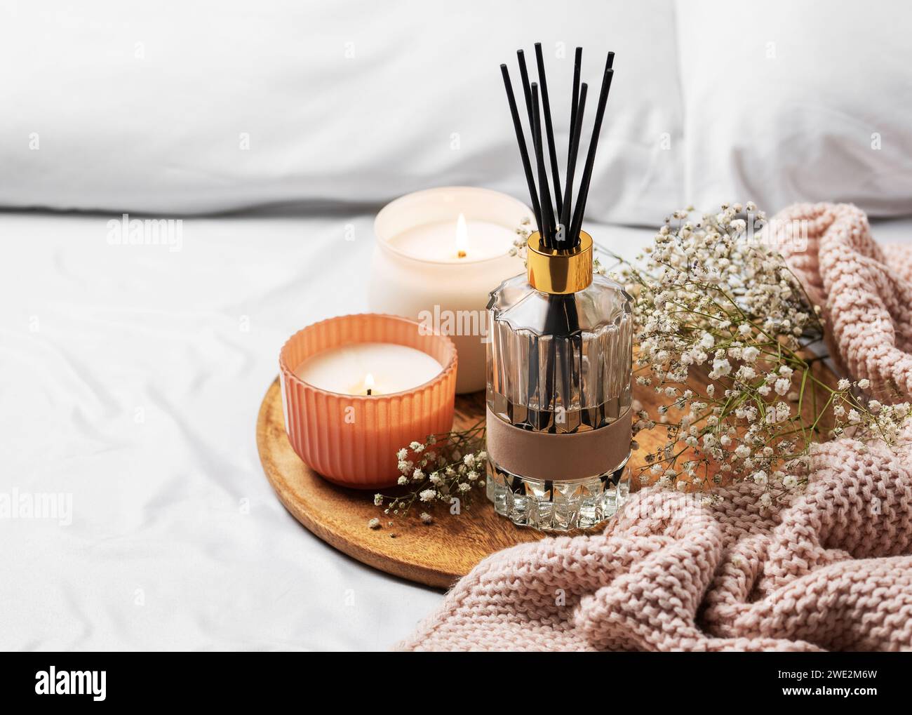 Cozy home atmosphere. Home liquid fragrance in glass bottle and scented ...