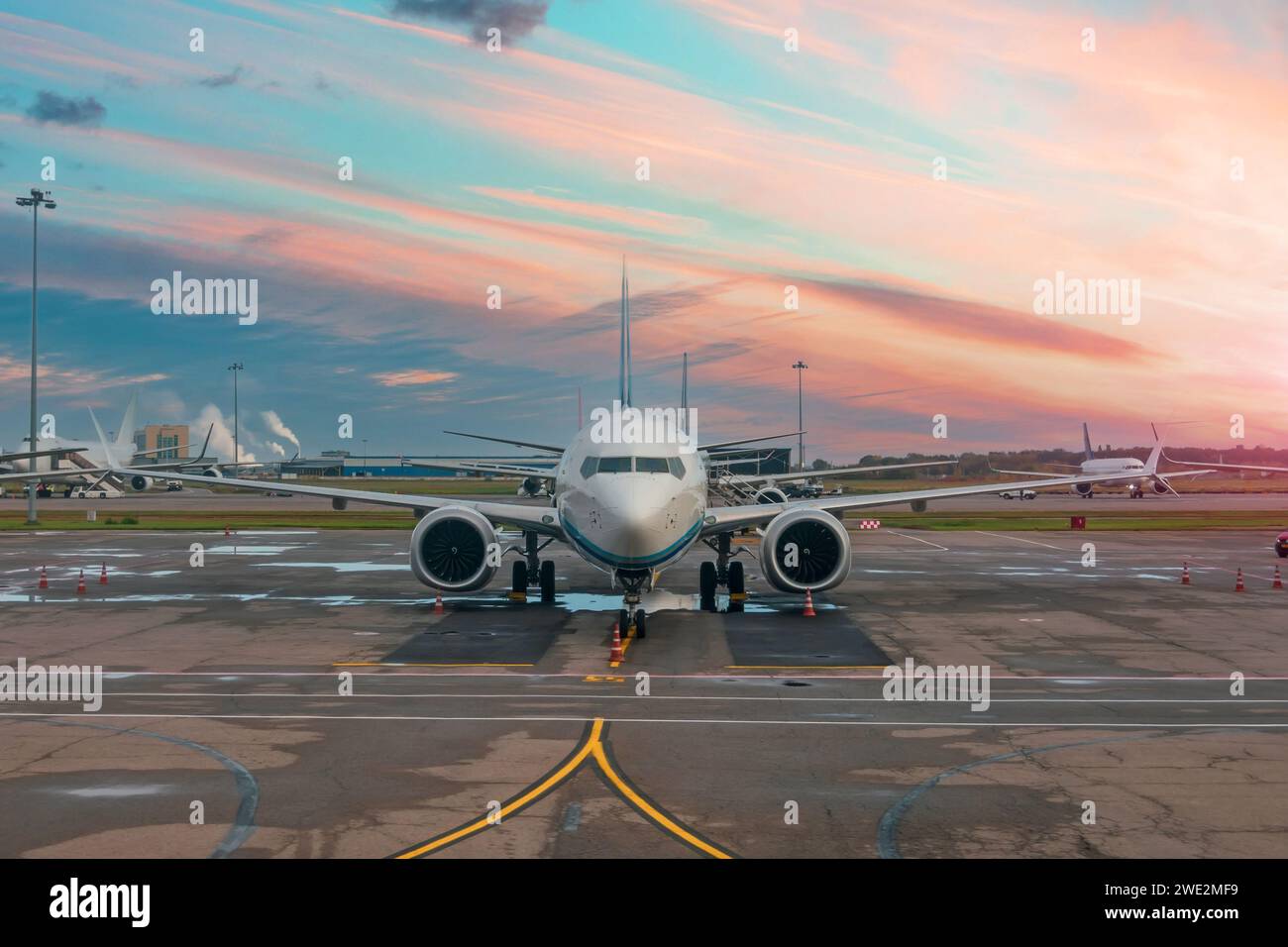 Passenger planes parked in the air harbor during dawn sky Stock Photo ...