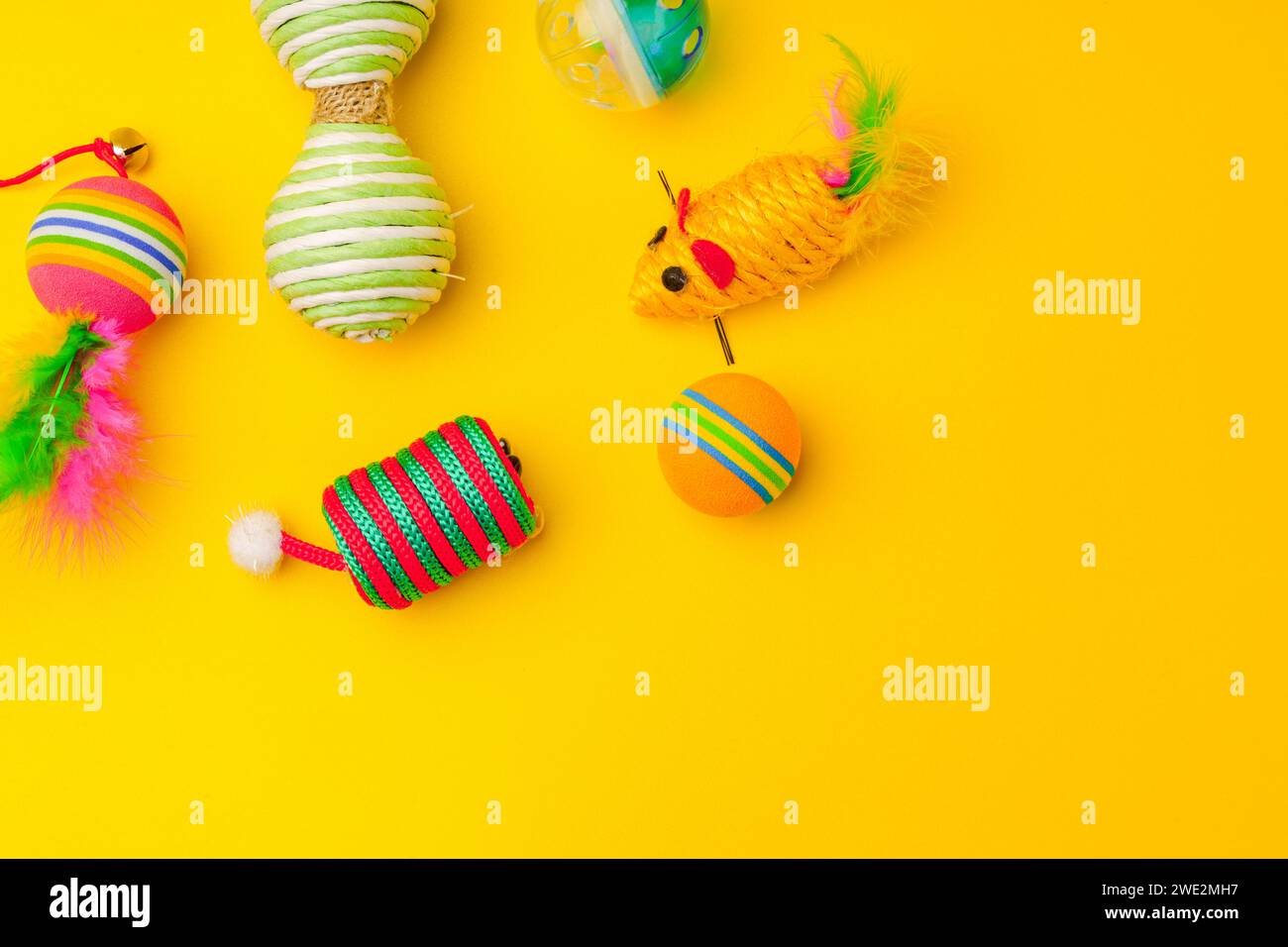 Pet toys on yellow background studio shot Stock Photo - Alamy