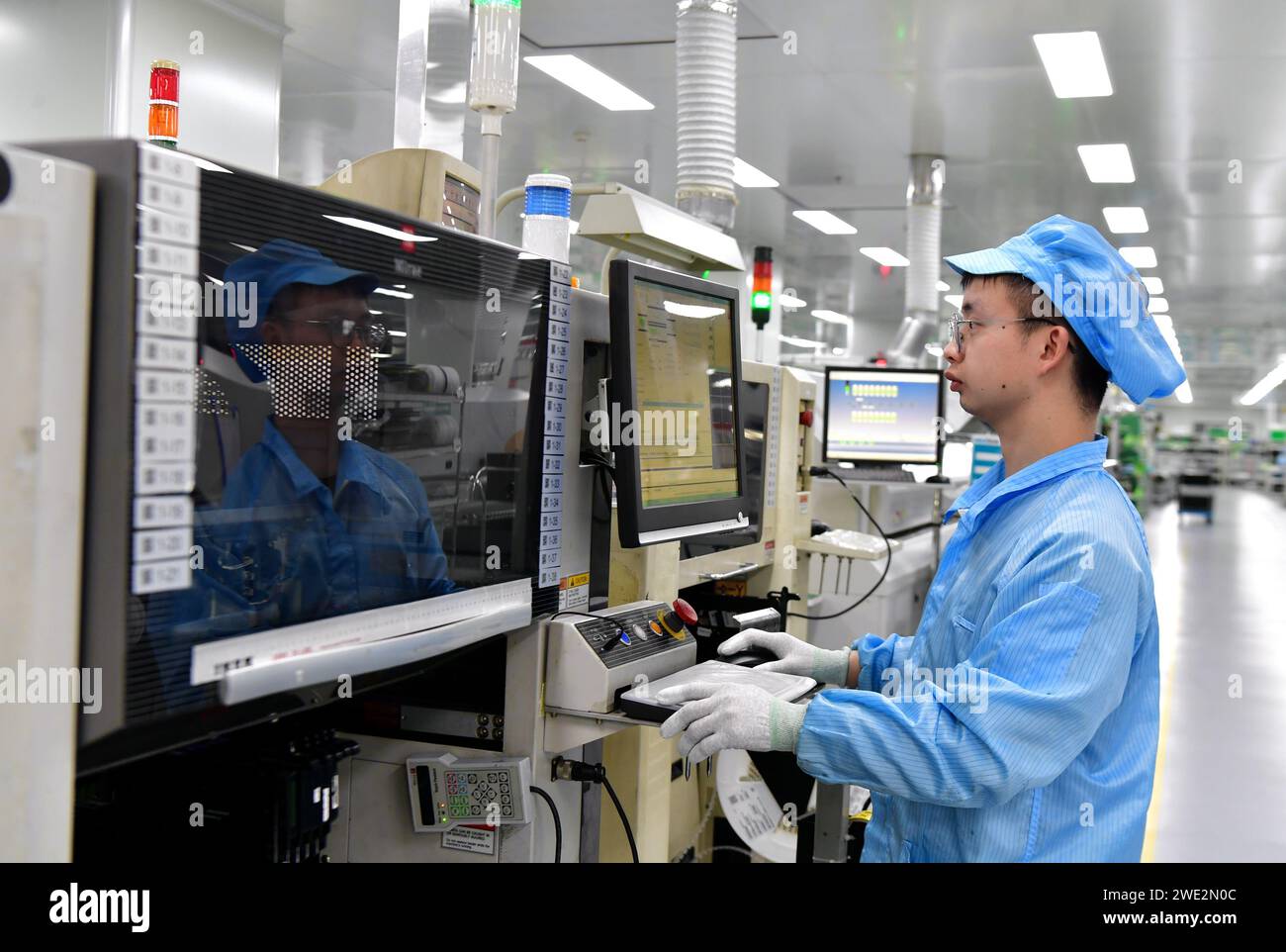 HAIAN, CHINA - JANUARY 23, 2024 - A skilled worker applies digital ...