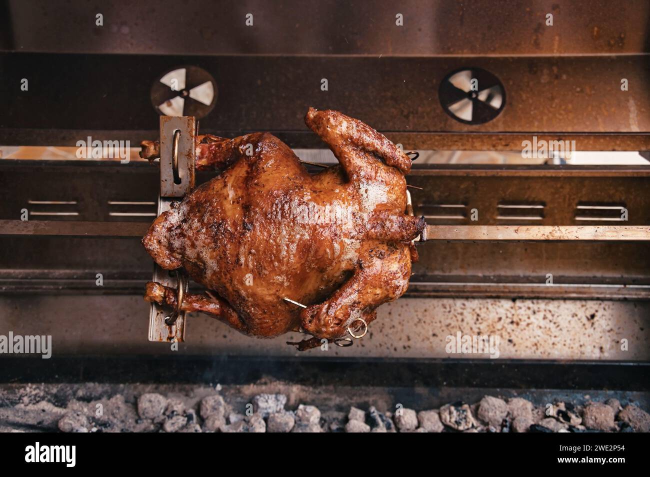 Preparing chicken on a spit Stock Photo - Alamy