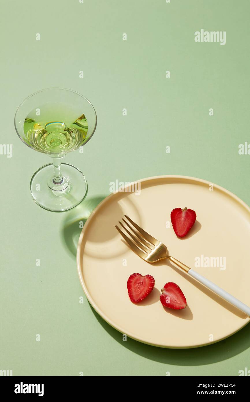 Minimal concept of drinks and dessert. Some strawberry slices with fork ...