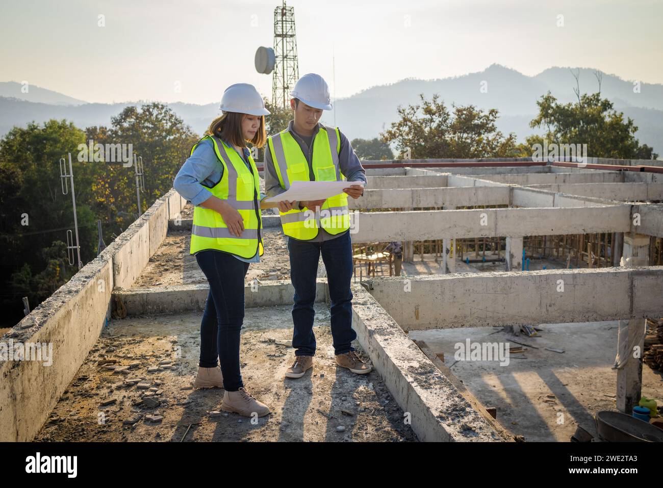 Construction engineer, team of construction engineers talks to managers and construction workers ...