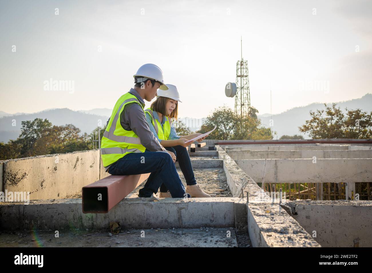 Construction engineer, team of construction engineers talks to managers and construction workers ...