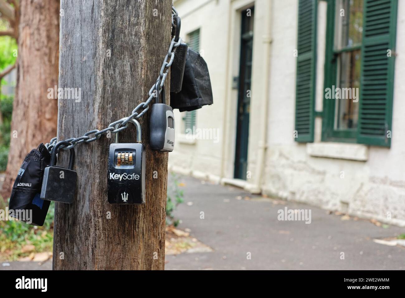 An inner city street of terrace houses, key safe boxes hang on a chain ...