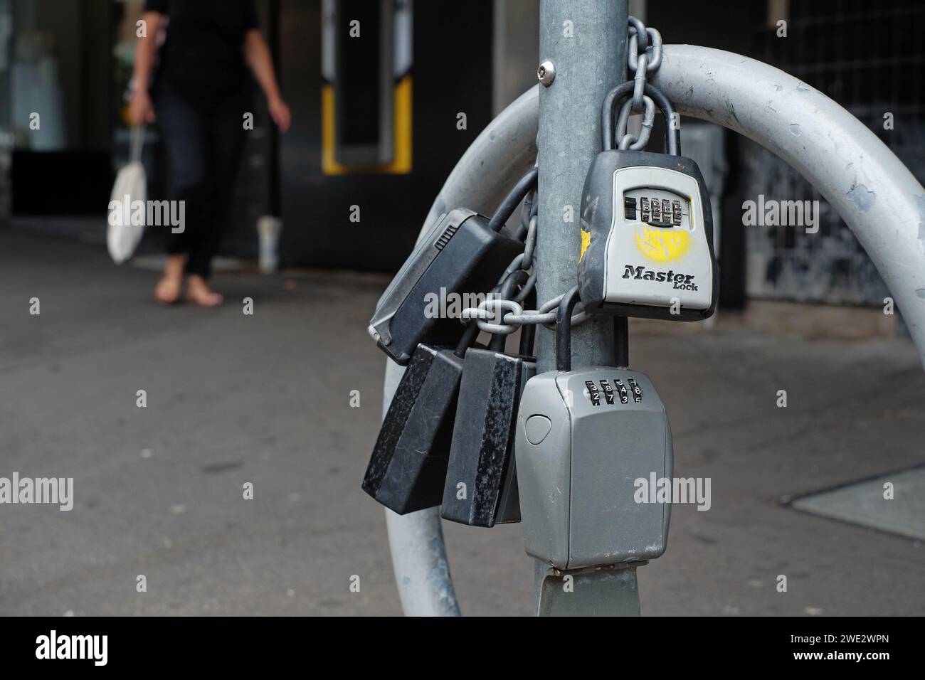 Key Safe padlock boxes wrapped in chains around a metal post on the ...