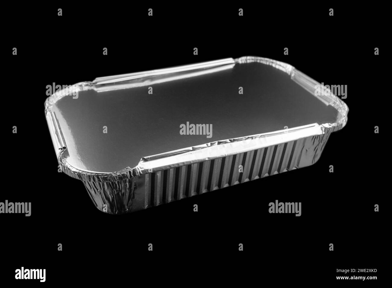 Foil baking dish closeup isolated on a black background. Empty ...
