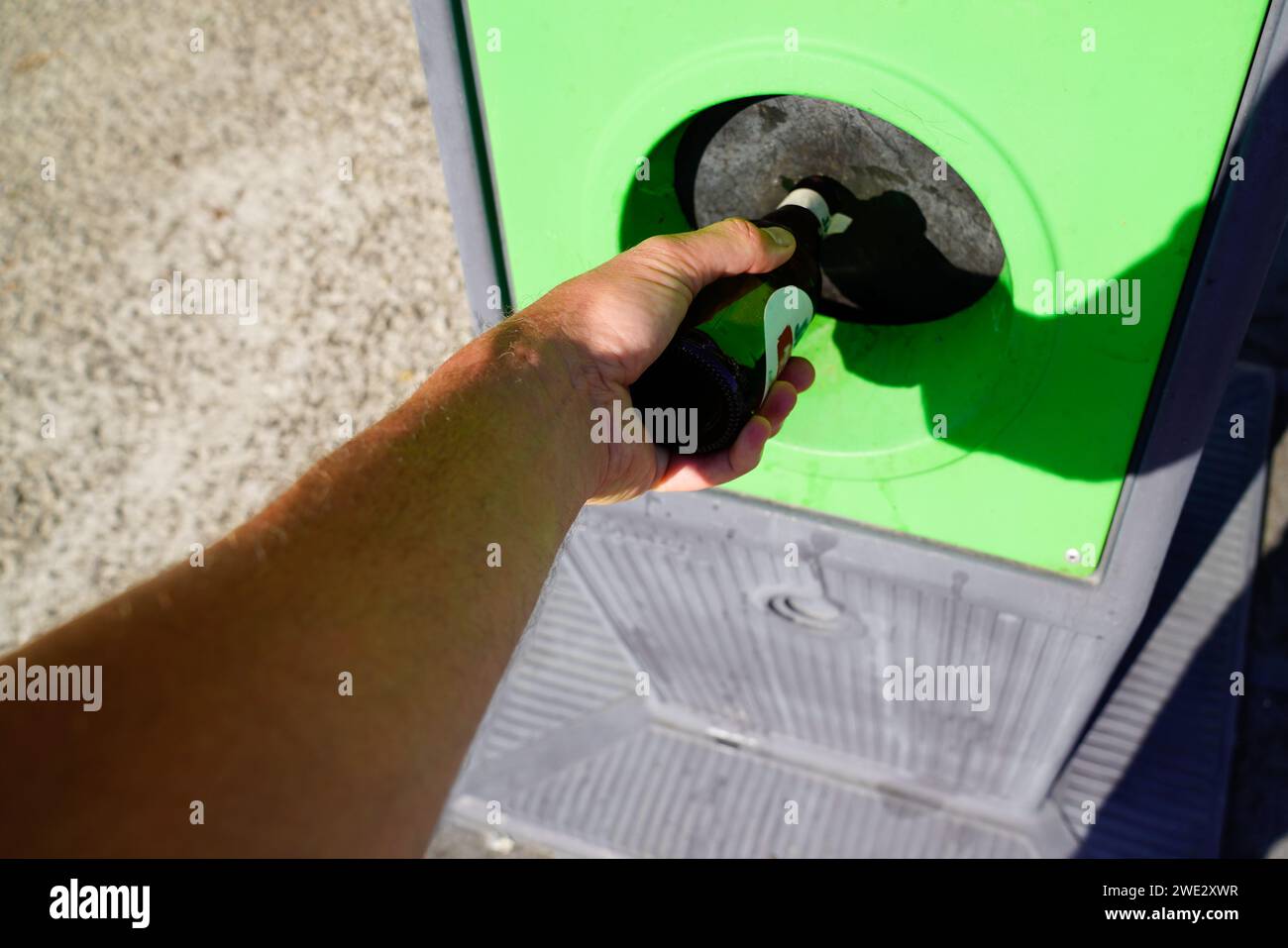 man hand discarded glass bottle in waste sorting bin concept campaign ...