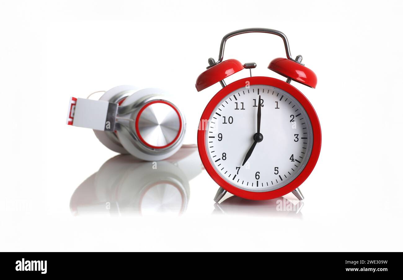 Red alarm clock with headphones isolated Stock Photo - Alamy