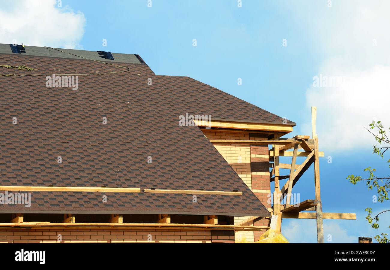 A close-up of an unfinished roofing construction with asphalt roofing ...