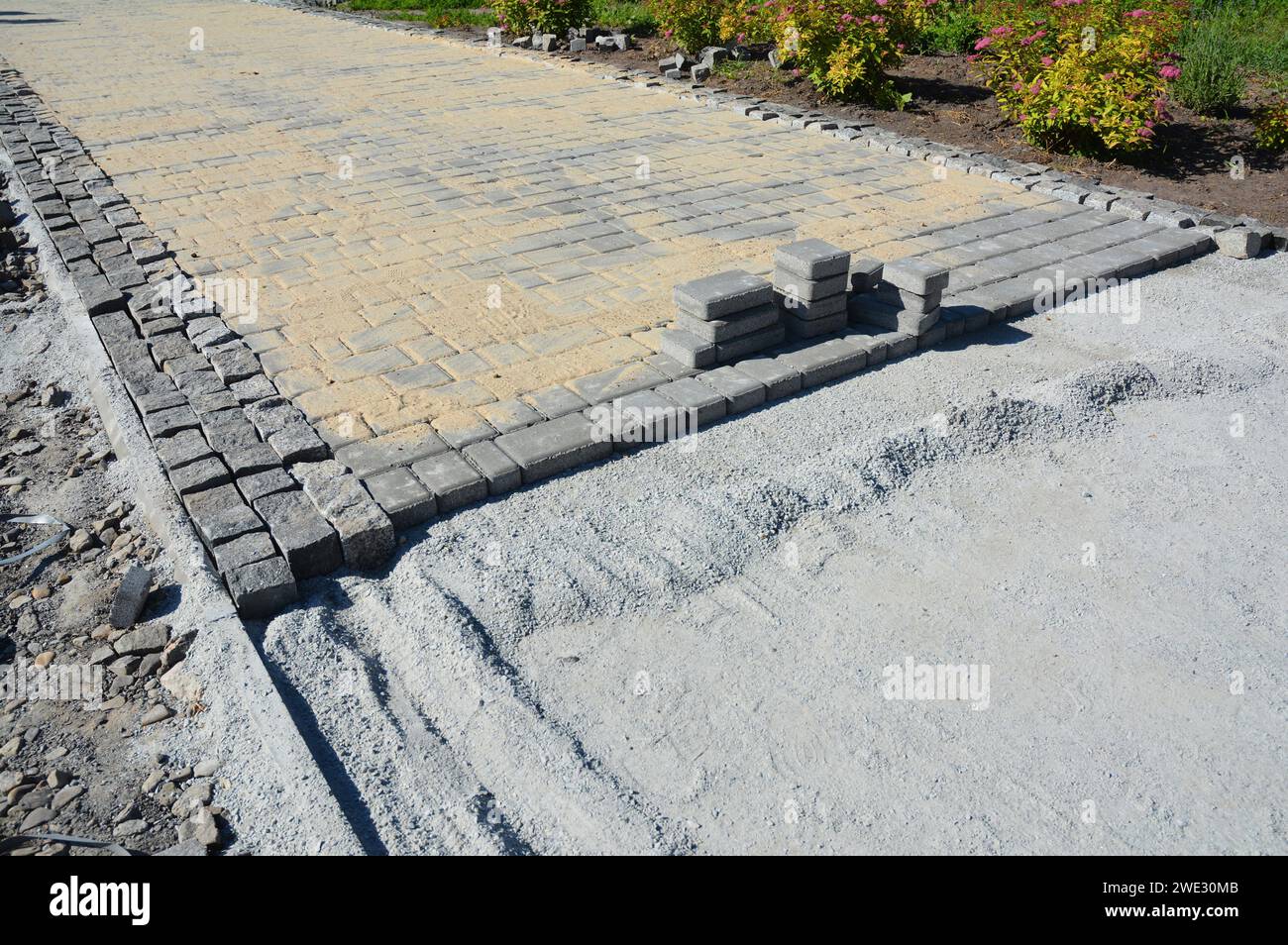 Close up view on laying paver stones in house garden. Pavement ...