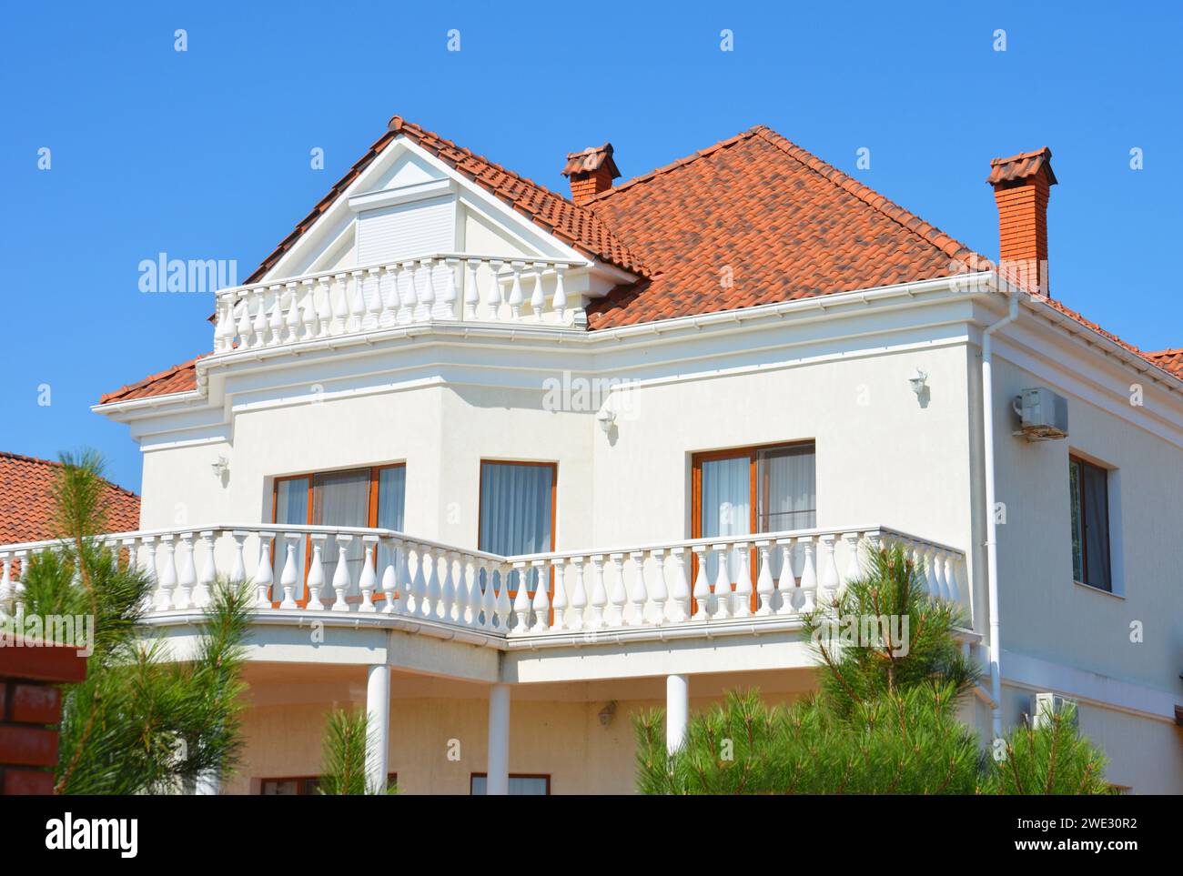 Luxury modern home with attic balcony and red clay tiles roof. Luxury ...