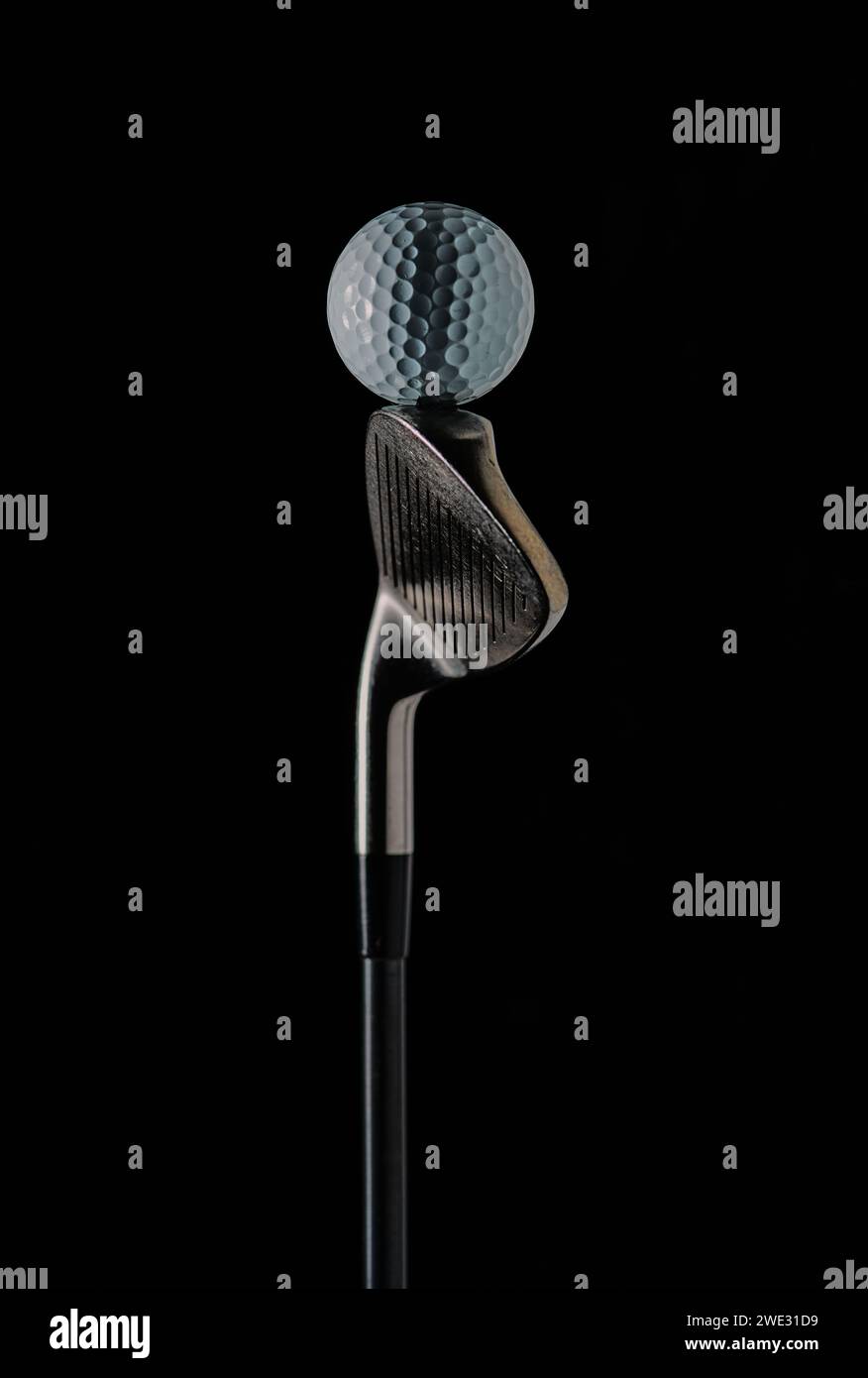 photo of a golf stick with the focus set on the golf ball on the stick ...