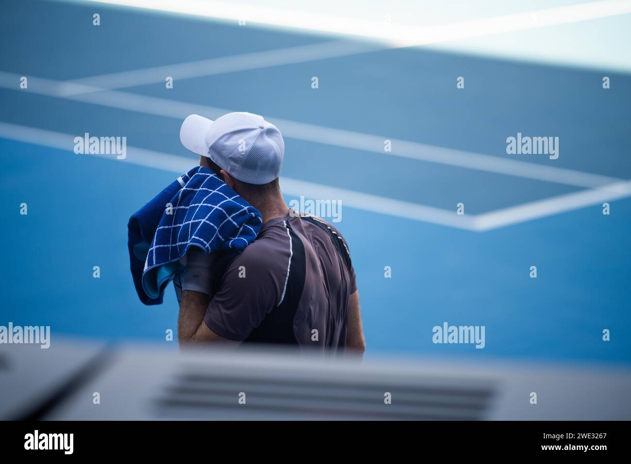 tennis player drying off with a towel on a tennis court in summer in ...