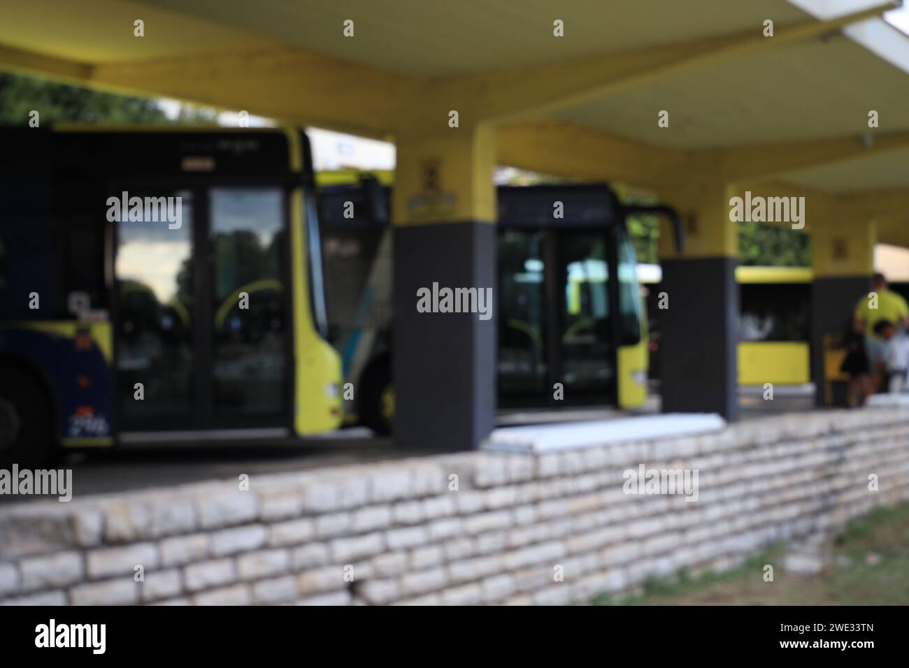 Blurred view of bus station with parked buses Stock Photo - Alamy