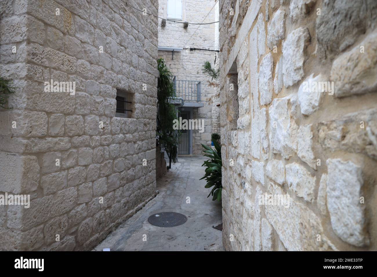 Picturesque view of passage between old buildings in city Stock Photo ...