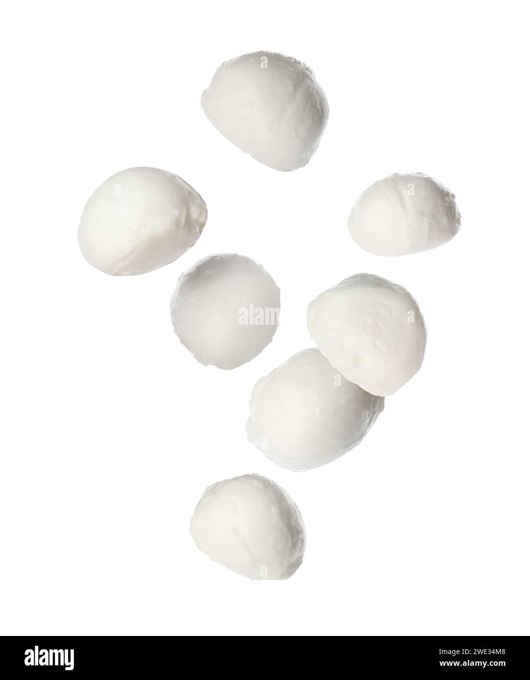 Fresh mozzarella balls falling on white background Stock Photo - Alamy