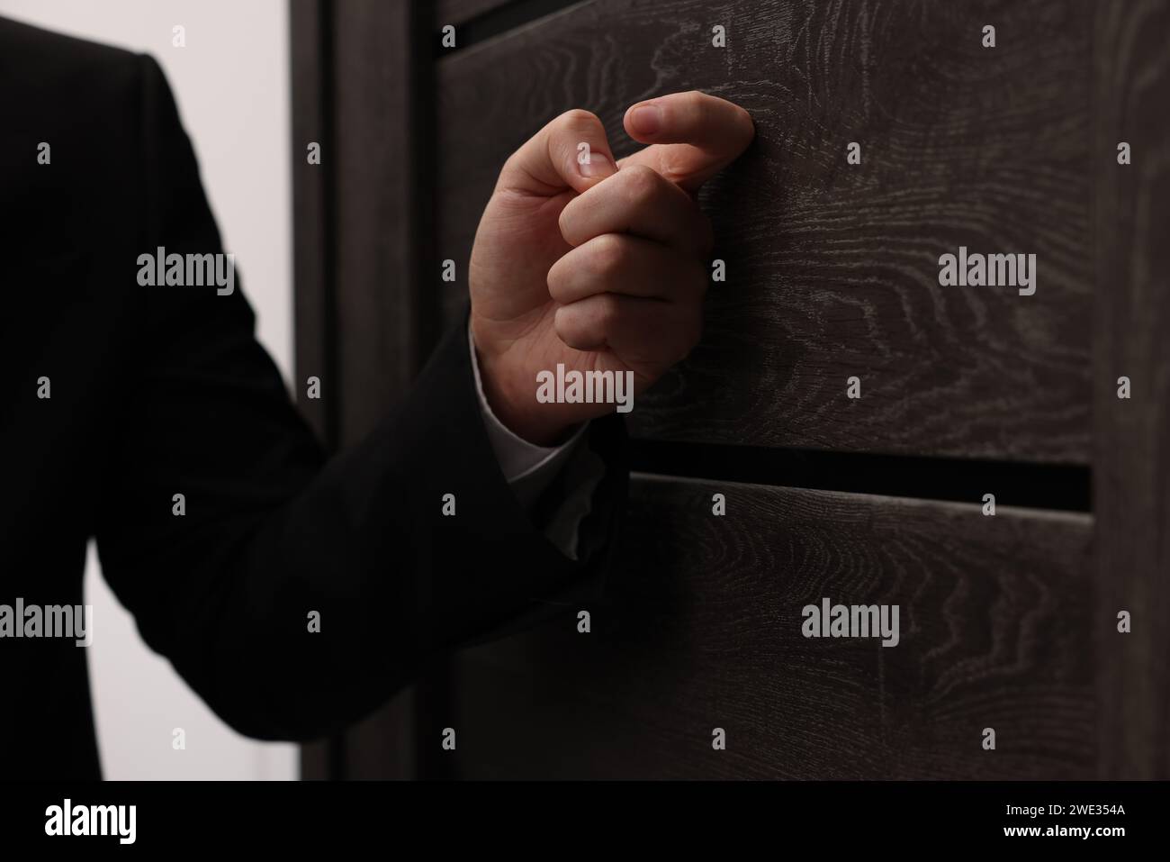 Collector knocking on door indoors, closeup view Stock Photo - Alamy