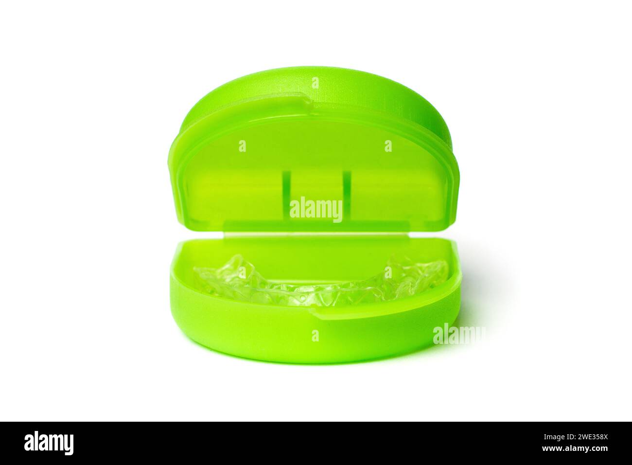Green box with invisible braces aligners on white background, dental ...