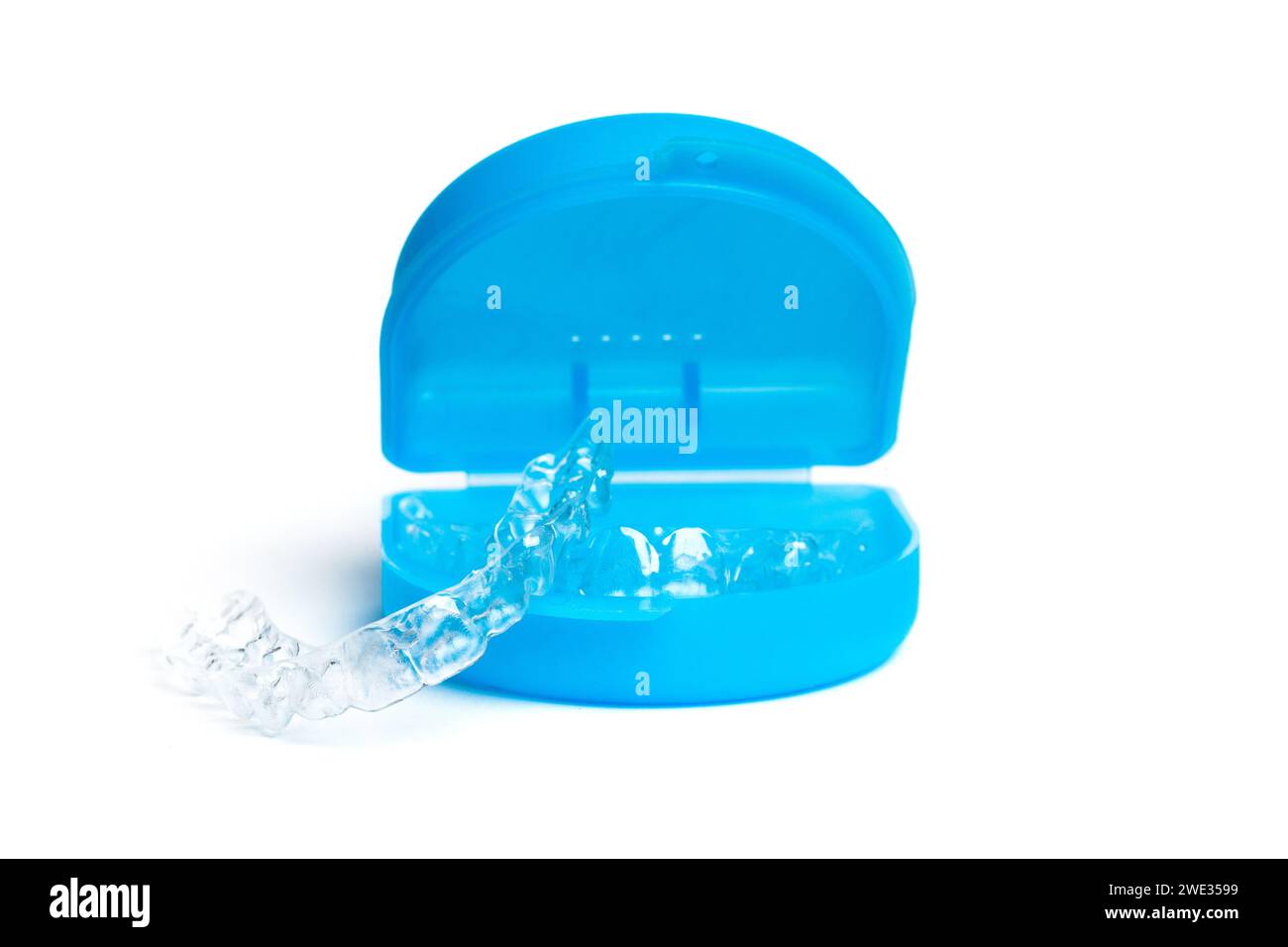 Vivid blue box with invisible braces on white background, dental ...
