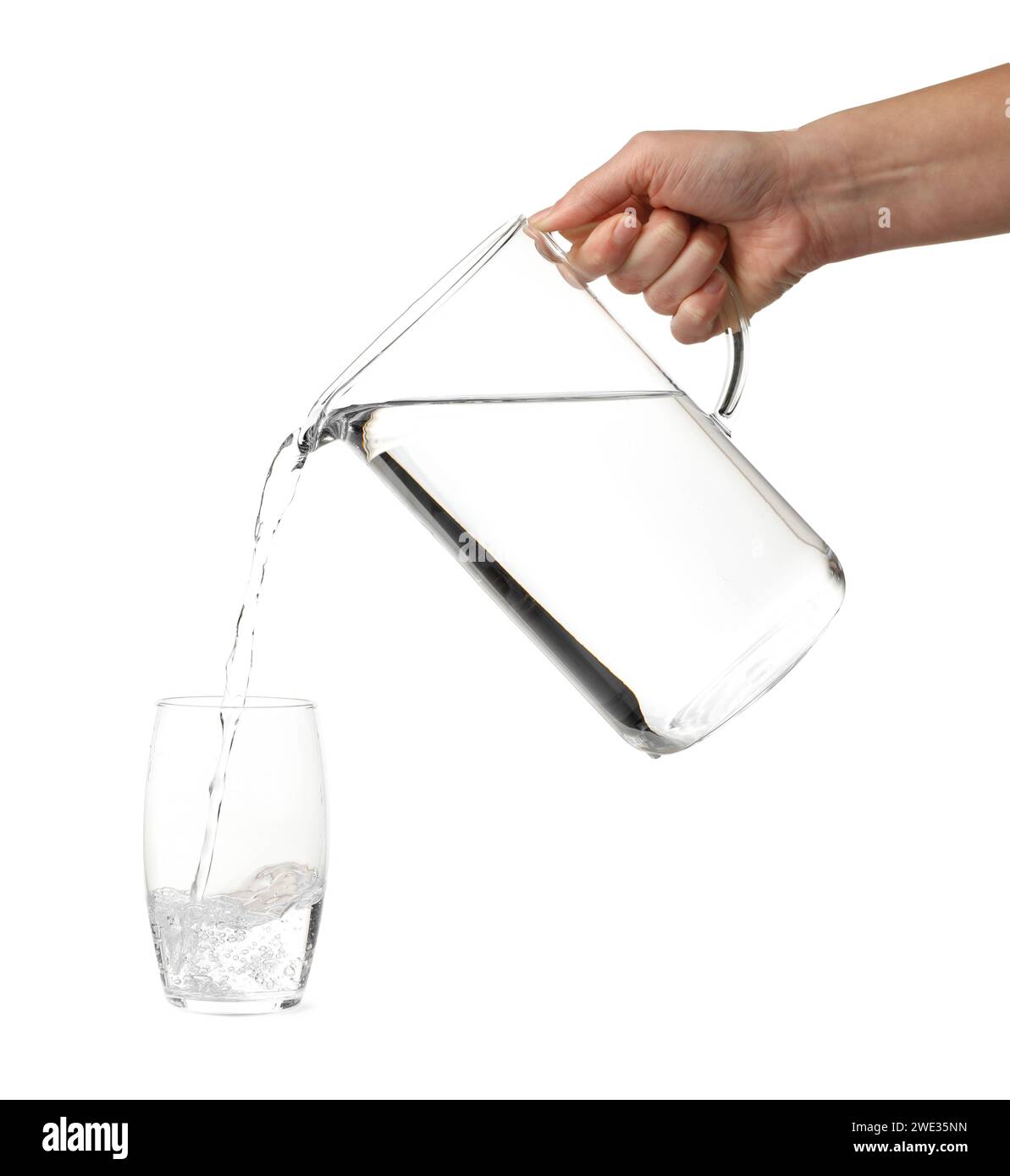 Woman pouring water from jug into glass on white background, closeup Stock Photo - Alamy