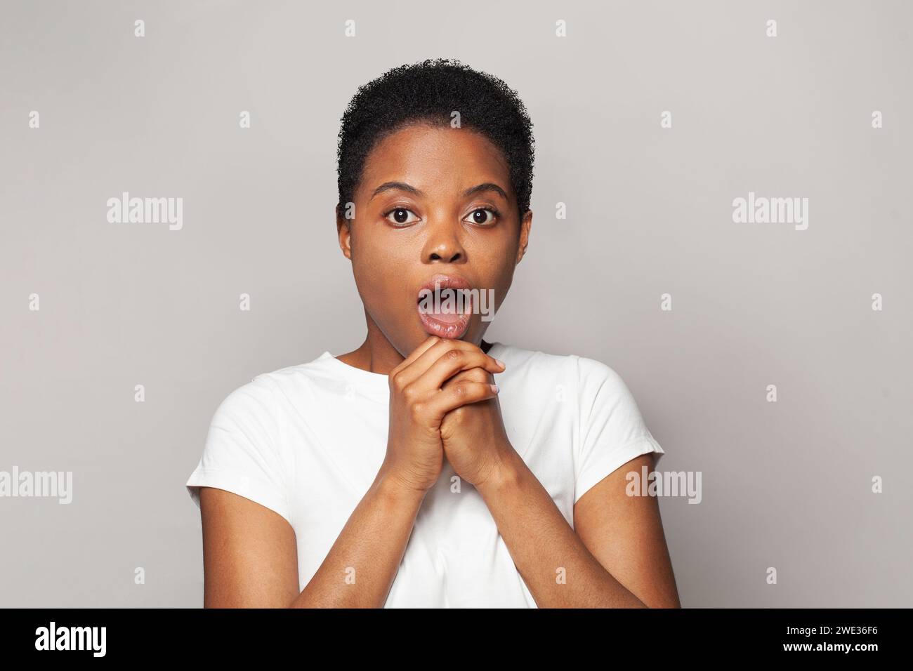 Excited shocked woman. Young emotional model, studio portrait. Surprise, shock and emotion ...