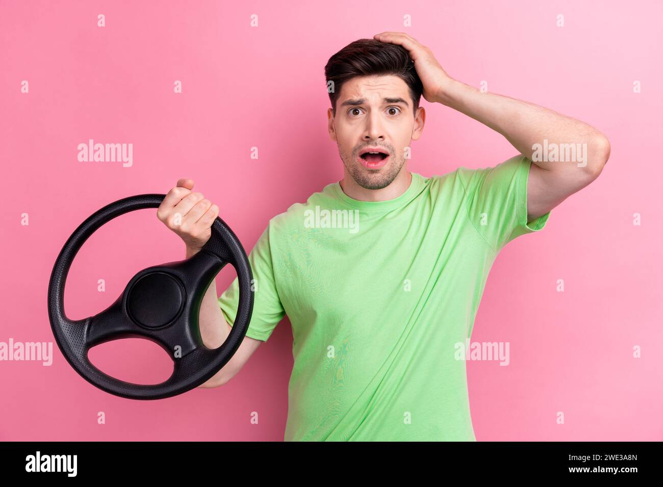 Photo of confused funny man driver holding steering wheel car part ...