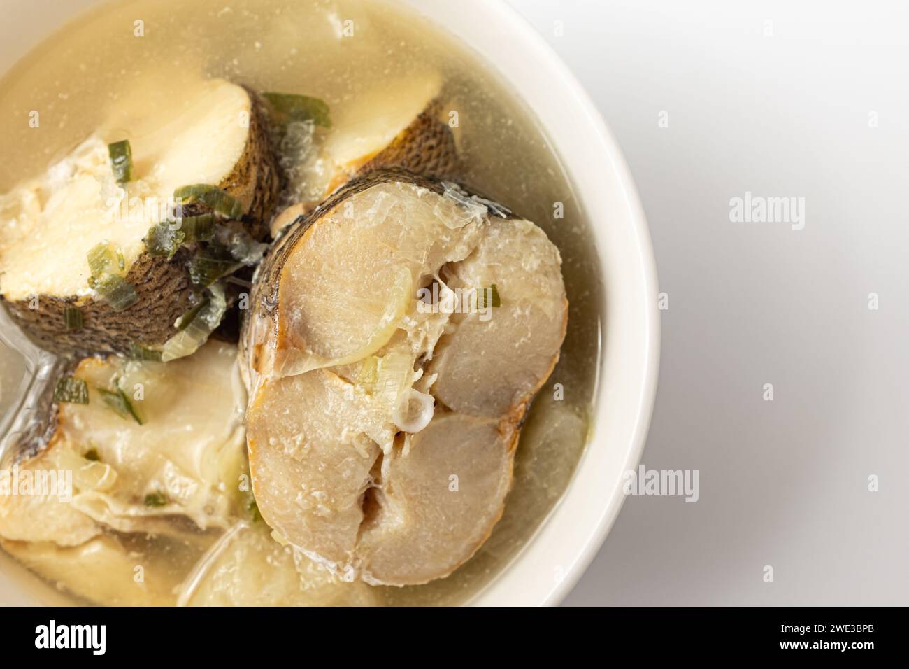 Cod soup on a white background Stock Photo - Alamy